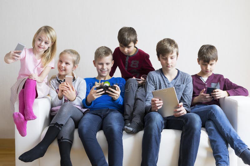 Kids using their gadgets stock photo. Image of children - 178649426