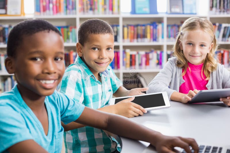 Kids Using Laptop and Digital Tablet in Library Stock Image - Image of ...