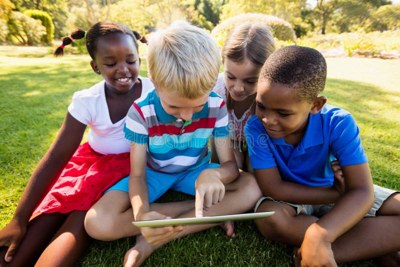Kids Using Technology during a Sunny Day Stock Image - Image of four ...