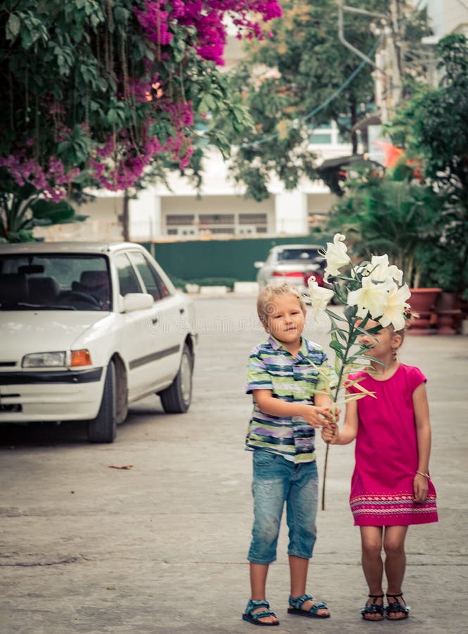 Kids walking by the street stock photo. Image of holding - 182466968