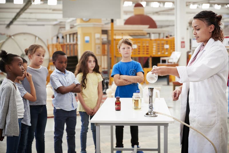 Kids Watching Lab Technician Carry Out a Science Experiment Stock Photo ...
