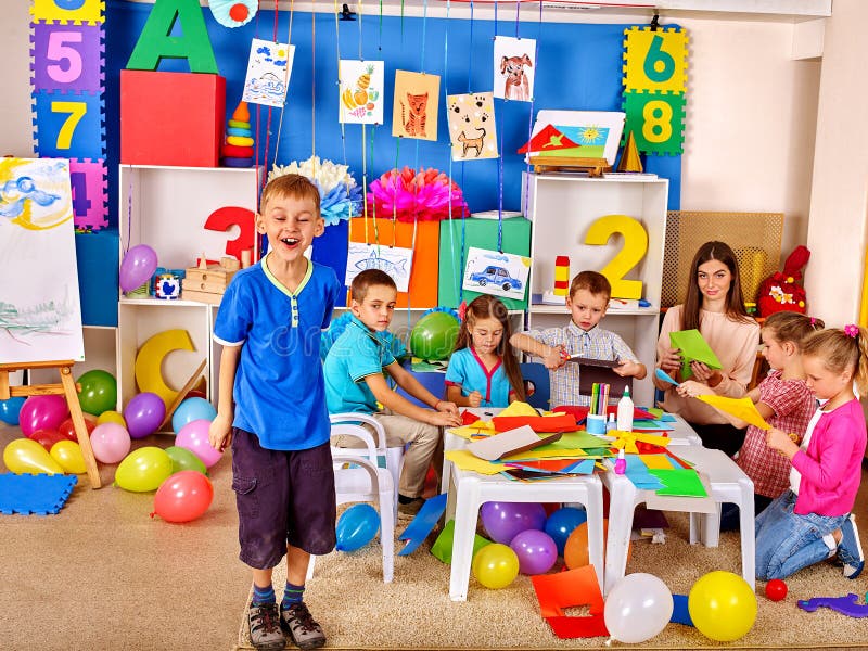Kids Working with Colored Paper on Table in Kindergarten . Stock Photo ...