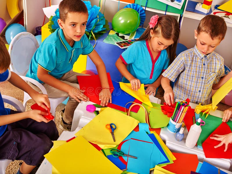 Kids Working with Paper on Table in Kindergarten . Stock Photo - Image ...