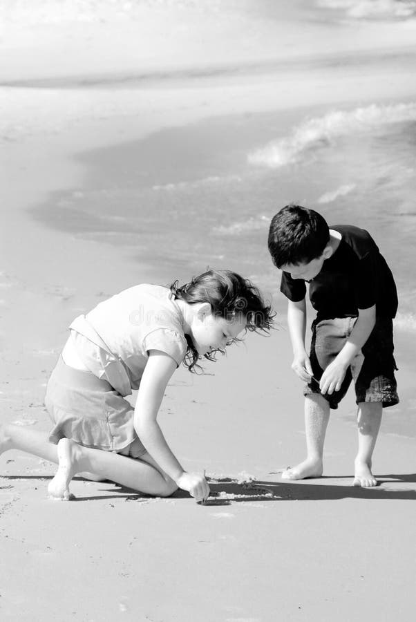 Kids writing in beach sand stock photo. Image of carefree - 9745908
