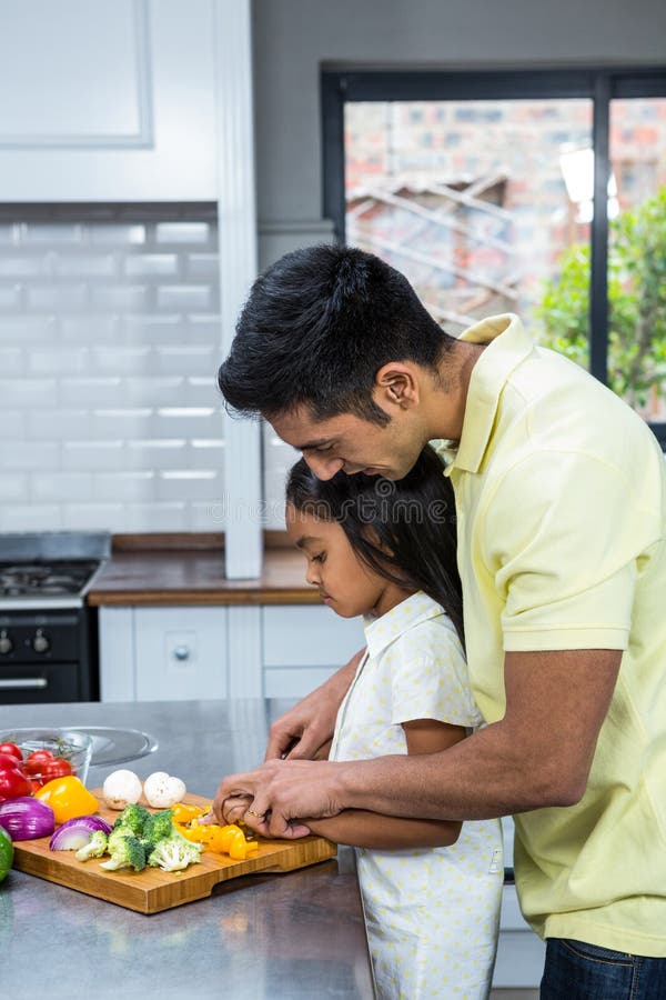 Kind Father Helping His Daughter Slicing Vegetables Stock Image - Image ...