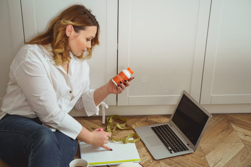 Serious Young Woman Looking at Plastic Package Stock Image - Image of ...