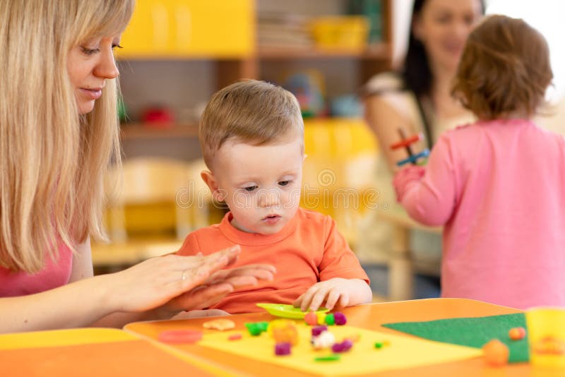 Kindergarten Kid Learning with Teacher in Nursery Stock Photo - Image ...