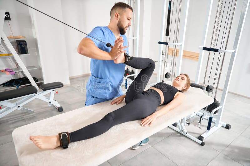 Kinesiologist Uses a Special Simulator To Work with a Patient Stock ...