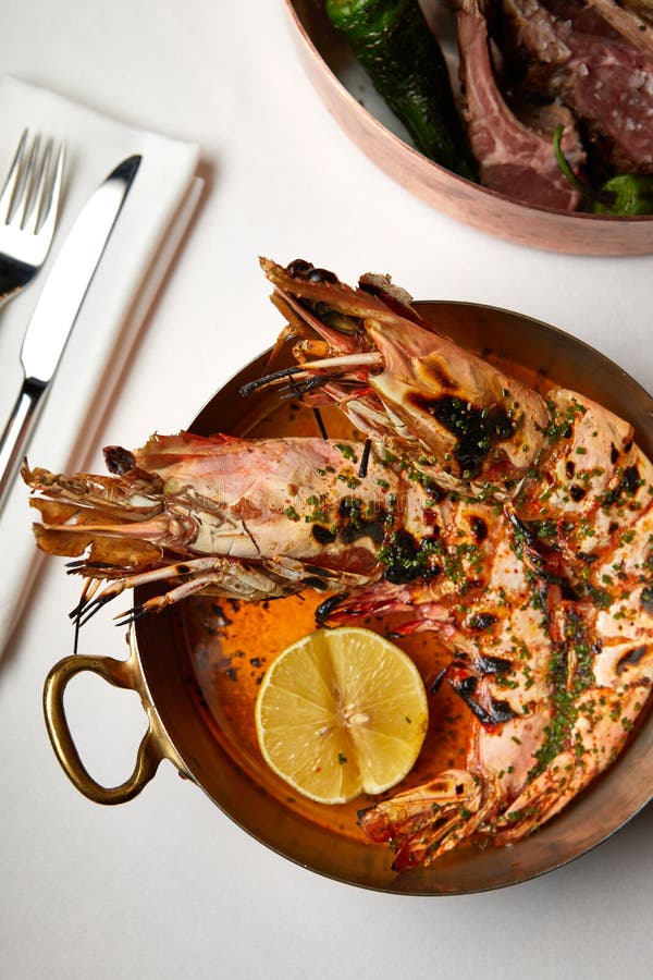 King Prawn in Sweet and Sour Sauce with Lemon in a Copper Dish on a ...