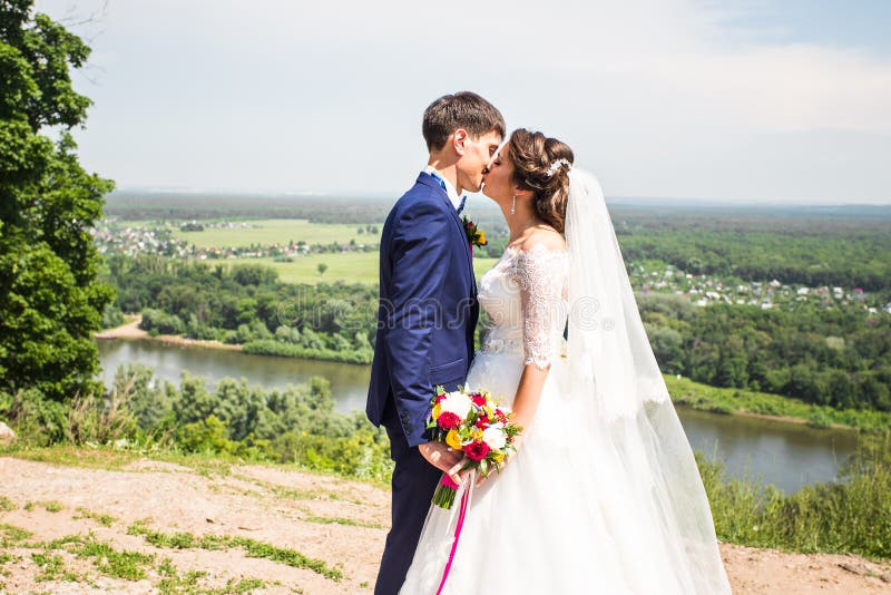 Kiss the Bride and Groom Outdoors Stock Image - Image of cheerful ...
