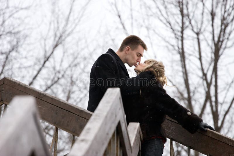 Kiss on a bridge stock photo. Image of nature, snow, togetherness - 4547092