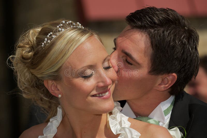 Kiss on her cheek stock photo. Image of wedding, groom - 16974280