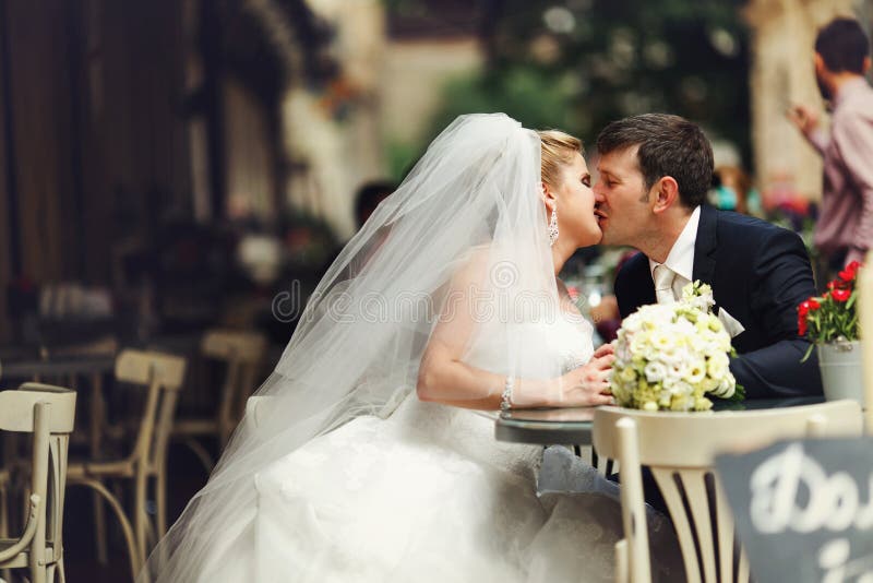 Kiss for the Lunch - Bride and Groom Kiss at the Table Stock Photo ...