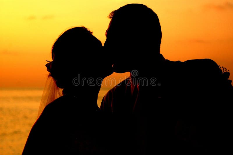 Kissing at sunset stock photo. Image of sunset, love, island - 1044558