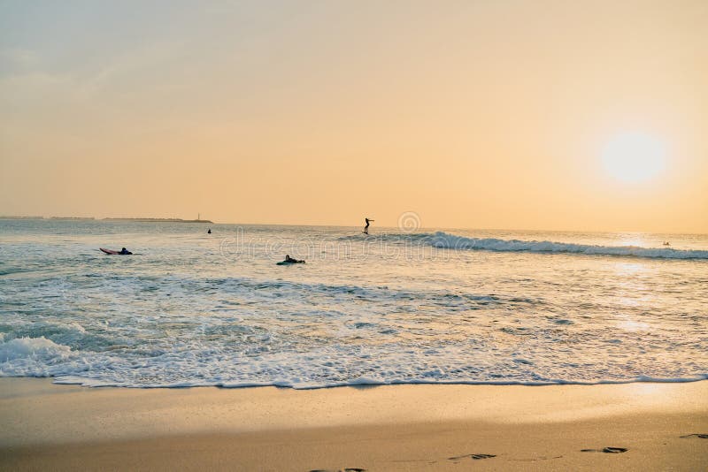 Kit surfing on the beach stock photo. Image of sunlight - 344905936