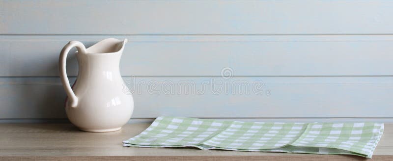 Kitchen Banner, a Table in Front of a White Board Wall and a Jug. a ...
