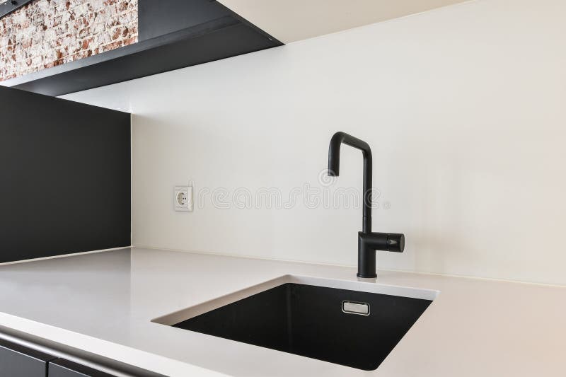 A Kitchen with a Black Sink and a Black Tap Stock Photo - Image of ...