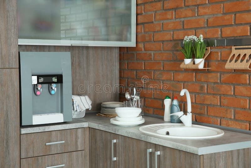 Kitchen Counter with Water Cooler, Sink and Clean Dishes Stock Image ...
