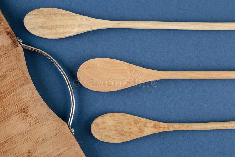Kitchen Cutting Board and a Wooden Spoon on a Blue Stock Photo - Image ...