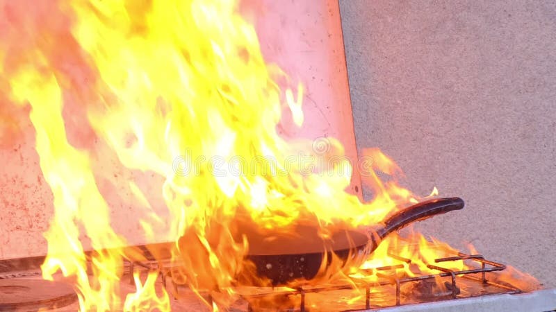 Kitchen on Fire with Flames Spreading Across Counter and Cabinets ...