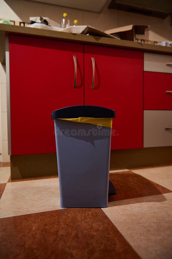 Kitchen Garbage Bin in a Clean Modern Kitchen with Red Cabinets Stock ...