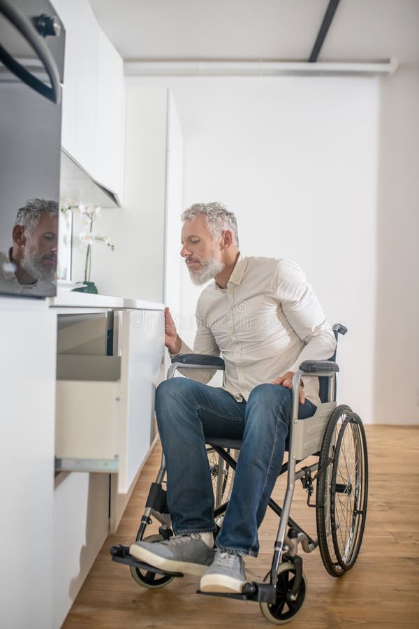 Gray-haired Handicapped Man in the Kitchen Getting the Breakfast Ready ...