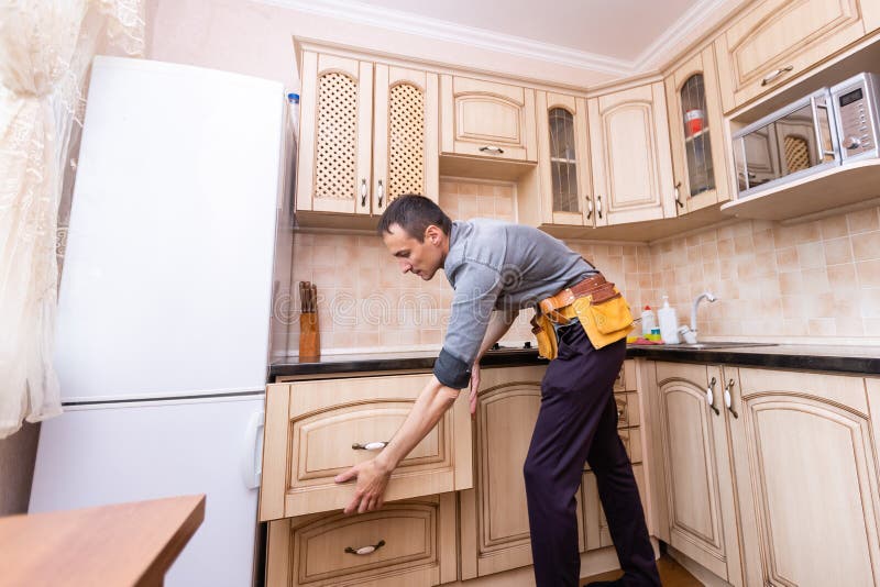 Kitchen Installation. Worker Assembling Furniture Stock Photo - Image ...