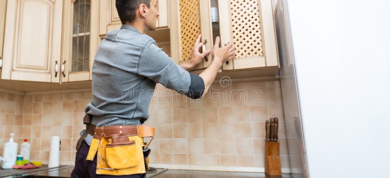 Kitchen Installation. Worker Assembling Furniture Stock Photo - Image ...