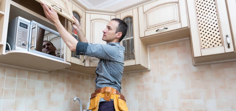 Kitchen Installation. Worker Assembling Furniture Stock Image - Image ...