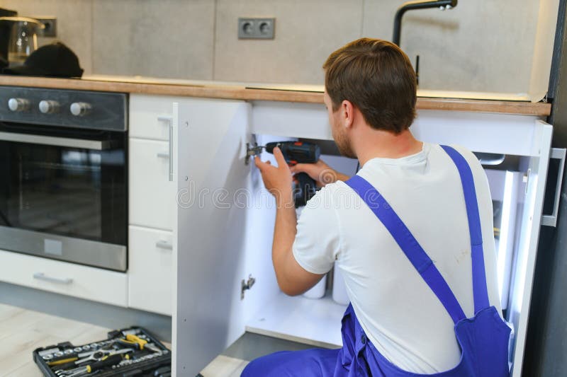 Kitchen Installation. Worker Assembling Furniture Stock Photo - Image ...
