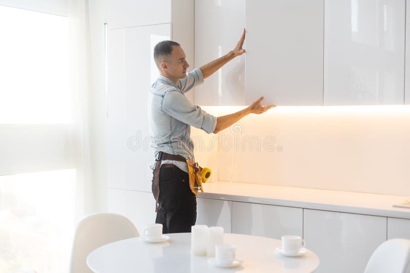 Kitchen Installation. Worker Assembling Furniture Stock Photo - Image ...