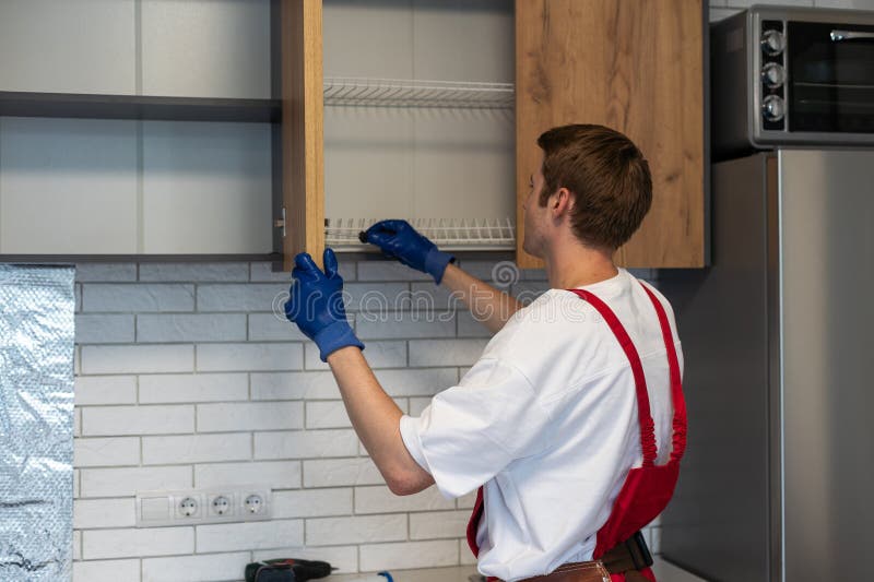 Kitchen Installation. Worker Assembling Furniture Stock Photo - Image ...