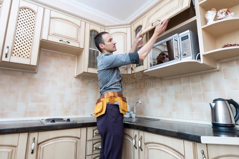 Kitchen Installation. Worker Assembling Furniture Stock Image - Image ...