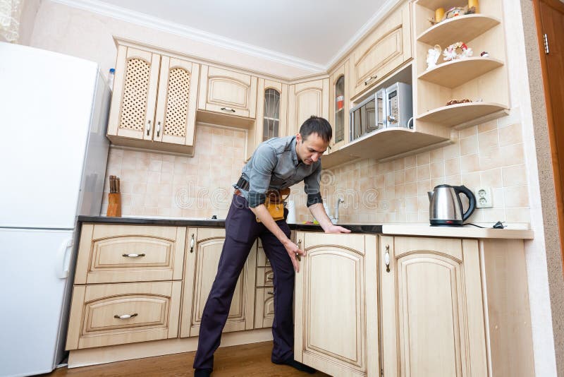 Kitchen Installation. Worker Assembling Furniture Stock Photo - Image ...