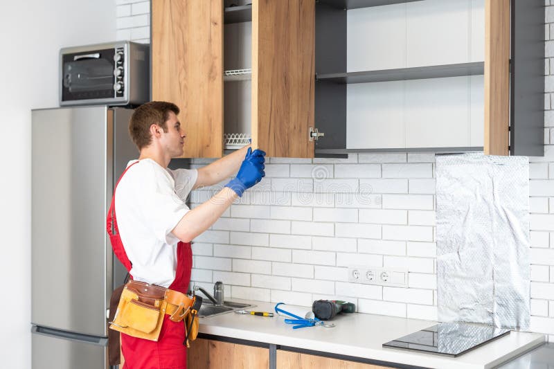 Kitchen Installation. Worker Assembling Furniture Stock Photo - Image ...