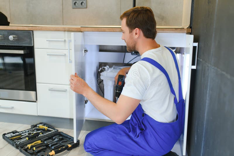 Kitchen Installation. Worker Assembling Furniture Stock Photo - Image ...