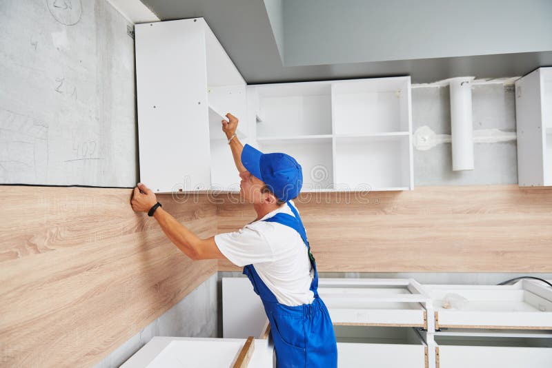 Kitchen Installation. Worker Assembling Furniture Stock Photo - Image ...