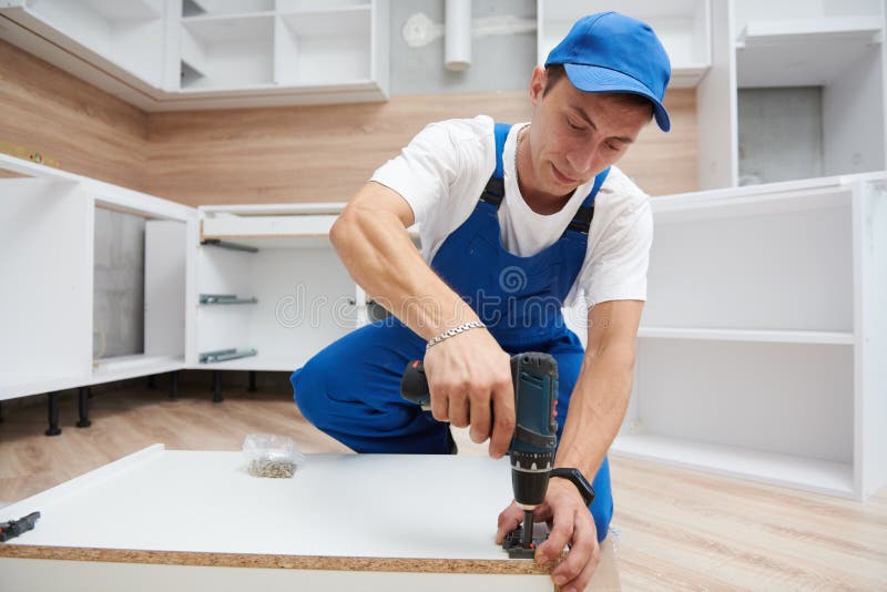 Kitchen Installation. Worker Assembling Furniture Stock Photo - Image ...
