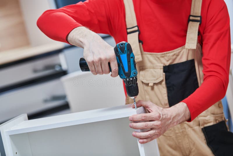 Kitchen Installation. Worker Assembling Furniture Stock Photo - Image ...