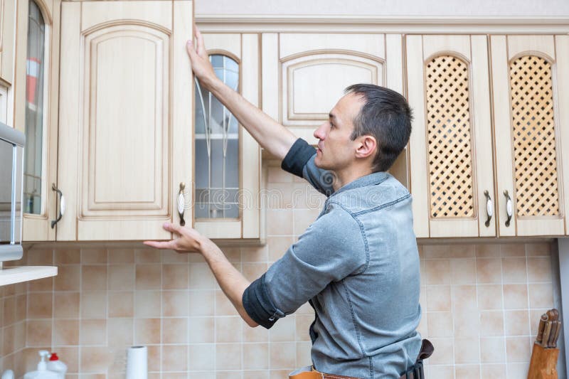 Kitchen Installation. Worker Assembling Furniture Stock Image - Image ...