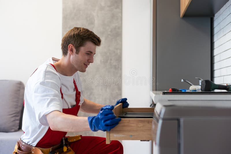 Kitchen Installation. Worker Assembling Furniture Stock Image - Image ...