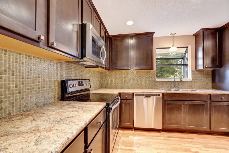Kitchen Interior with Brown Cabinets and Granite Tops. Stock Image ...