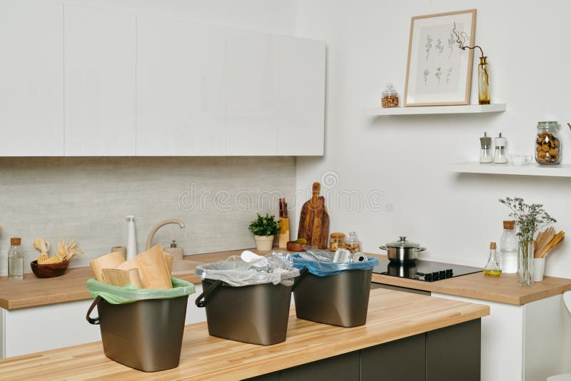 A Kitchen with Kitchenware and Group of Plastic Trash Bins Stock Photo ...