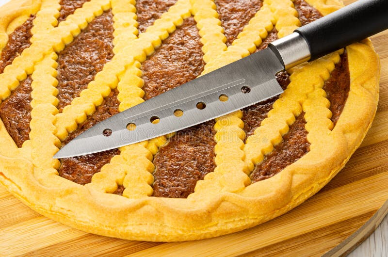 Knife on Pie with Boiled Condensed Milk on Bamboo Cutting Board Stock ...