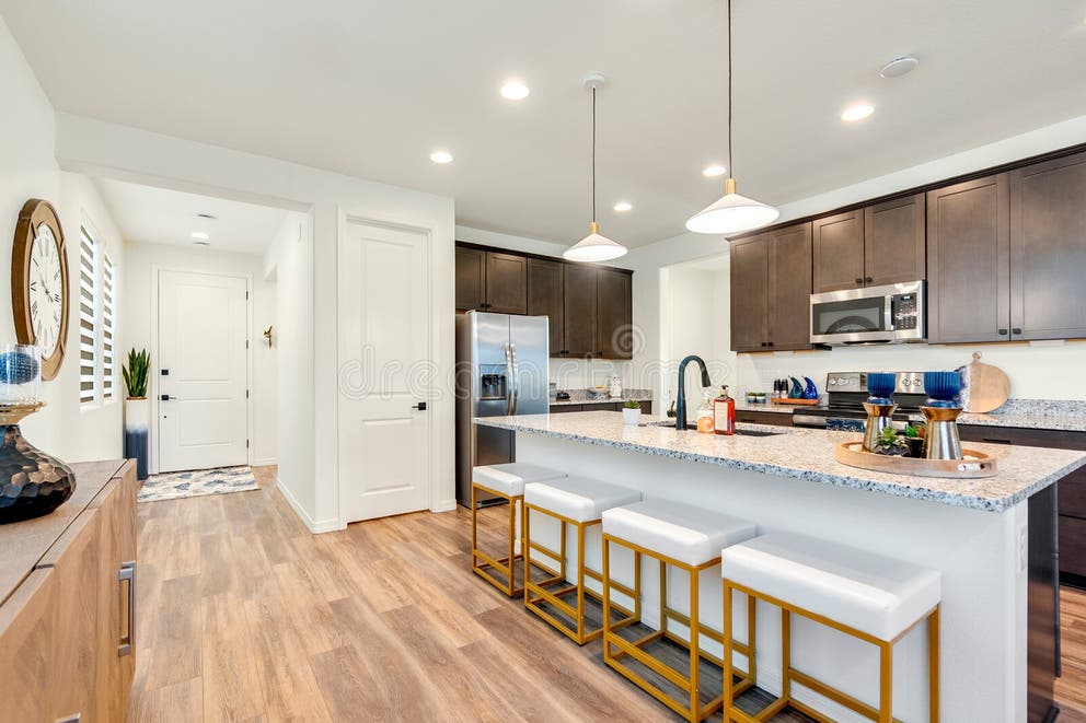 A Kitchen with a Large Island, Matching Stools, and Spacious Fridge ...
