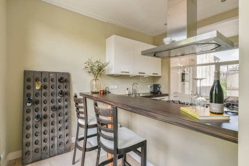 A Kitchen with a Long Bar with Three Stools Editorial Stock Photo ...
