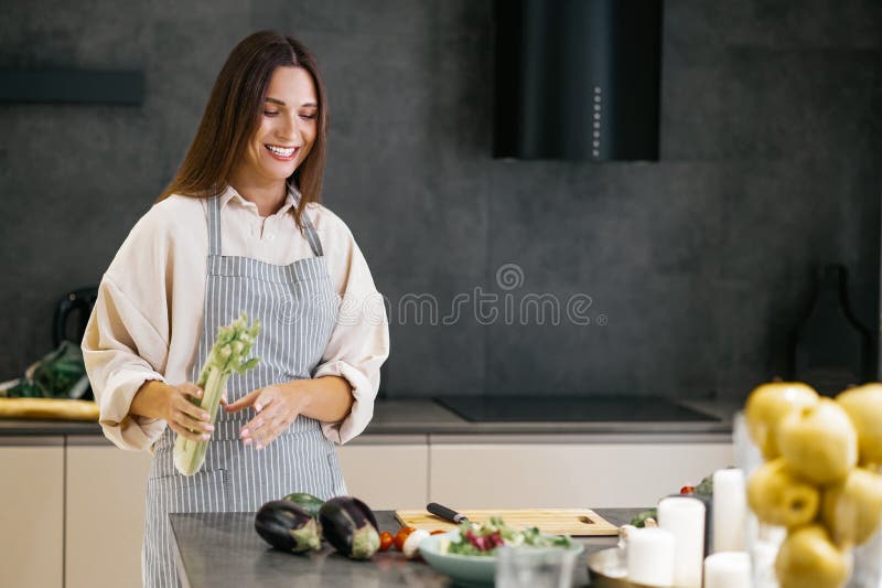 Long-haired Young Woman Preparing Lunch in the Kitchen Stock Photo ...