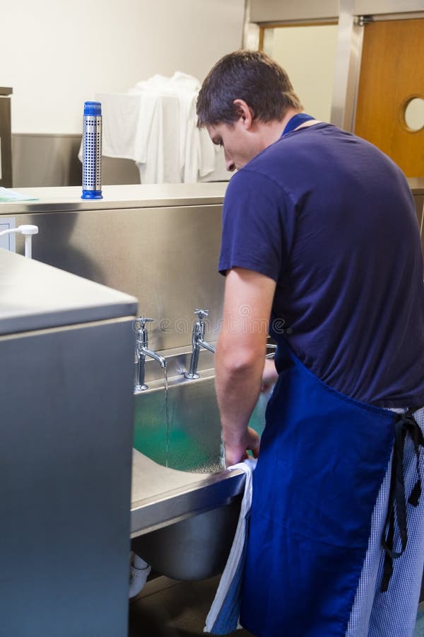 Kitchen Porter Standing Behind Sink Stock Photo - Image of person ...