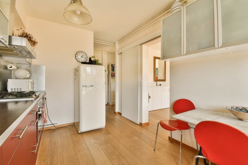 A Kitchen with a Table and Chairs and a Refrigerator Stock Photo ...