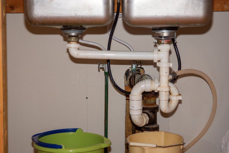 Kitchen Remodel Closeup of Under Sink Plumbing with Buckets Stock Photo ...